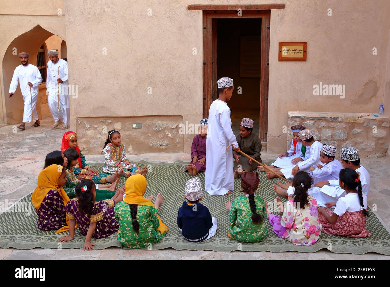 NIZWA, AL DAKHILIYAH, OMAN - DECEMBER 20, 2024: Omani children colorfully dressed and performing ...