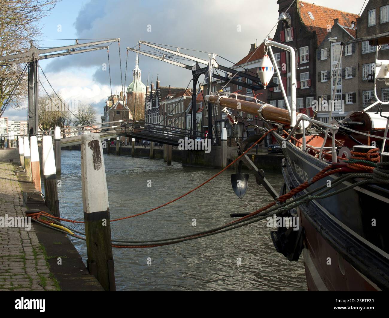 A sailing ship next to an old bridge in a historic town, Dordrecht. The ...