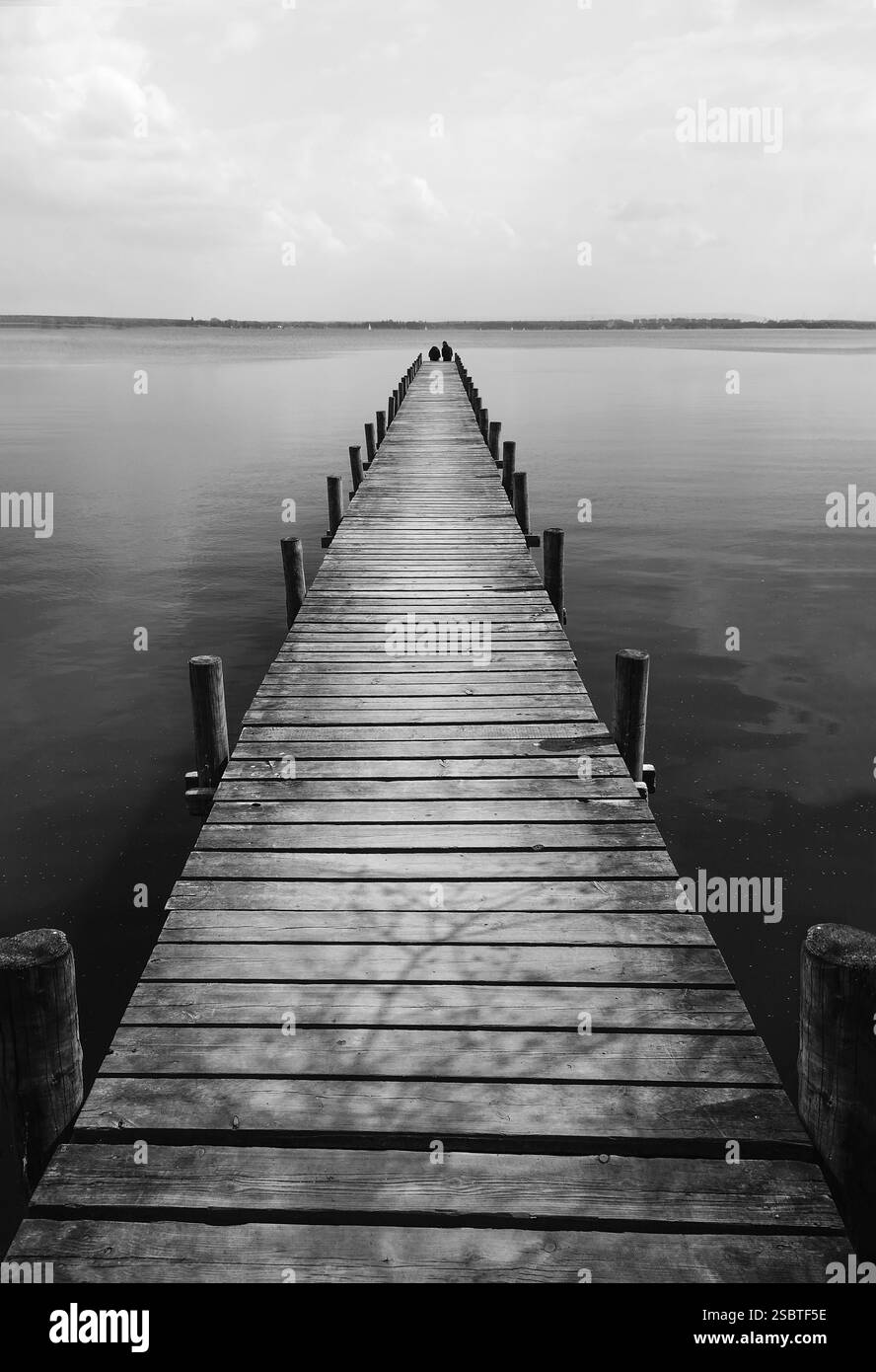 Long Wooden pier at silence lake, monochrome shoot Stock Photo - Alamy
