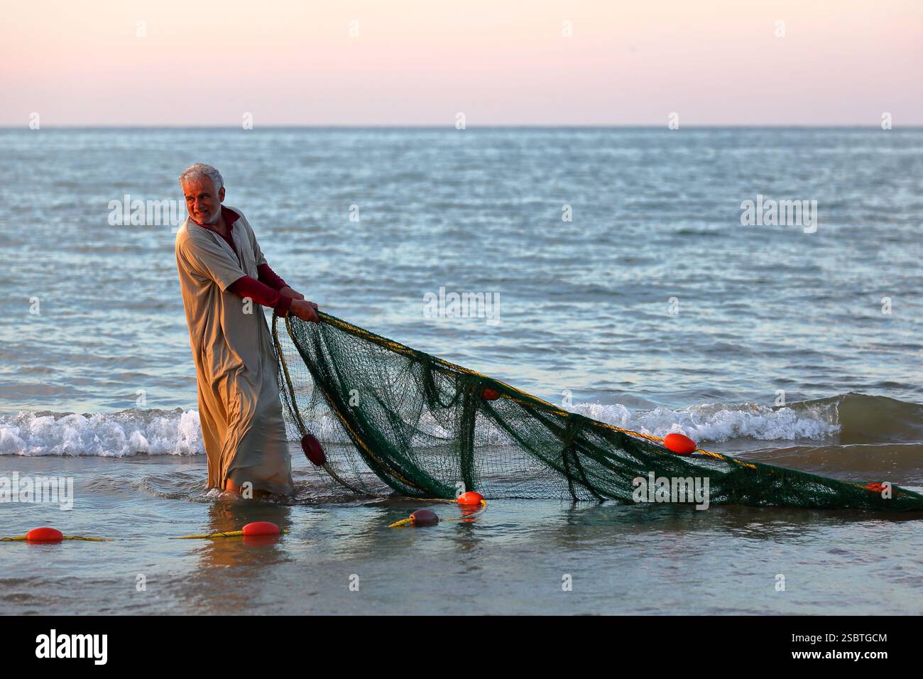 QURUM BEACH, MUSCAT, OMAN - DECEMBER 28, 2024: Omani fisherman ...
