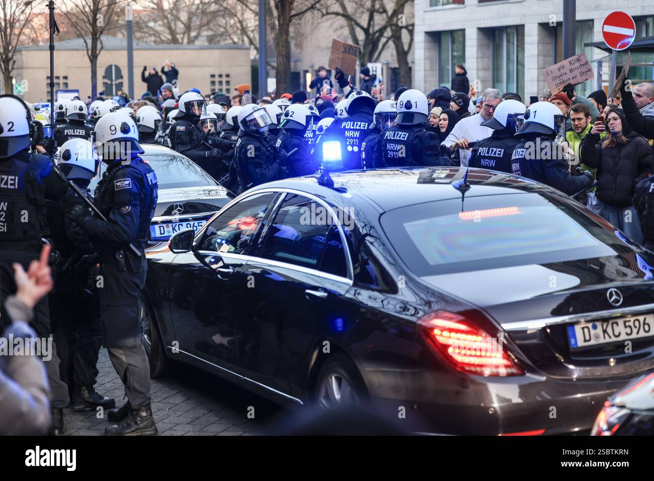 04 February 2025, North Rhine-Westphalia, Cologne: Police officers push ...