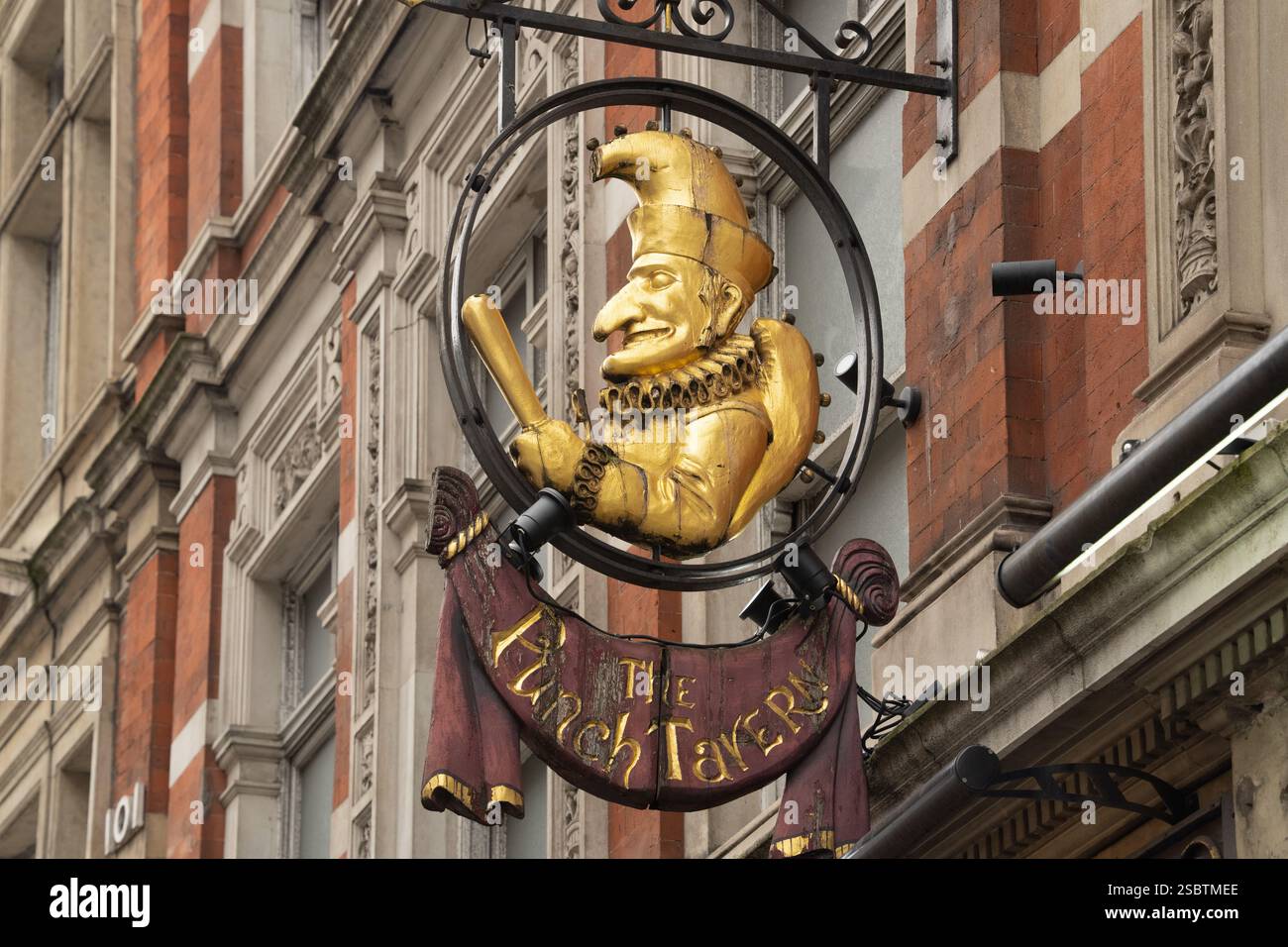 A golden jester sign advertises "The Pinch Tavern Stock Photo - Alamy