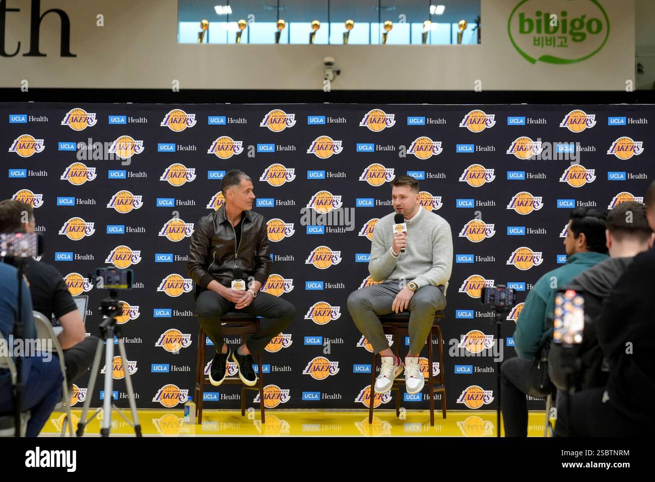 Los Angeles Lakers' Luka Doncic speaks next to general manager Rob ...
