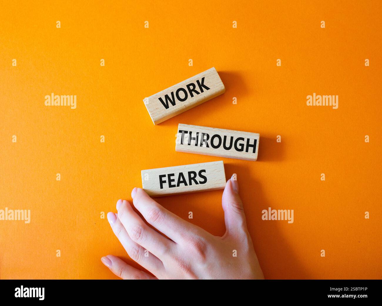Work through fears symbol. Wooden blocks with words Work through fears ...