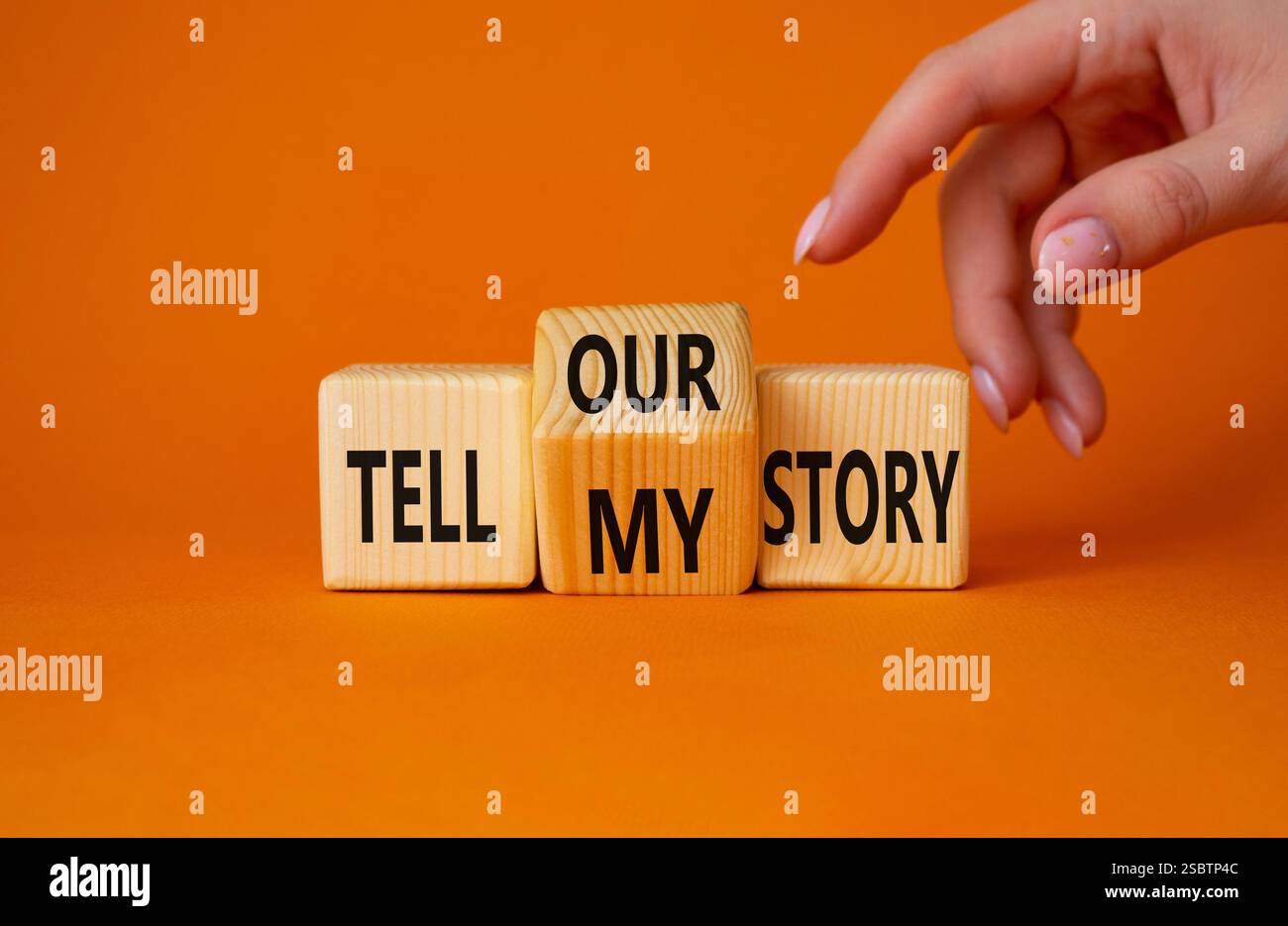 Tell our or my story symbol. Businessman hand points at turned wooden ...