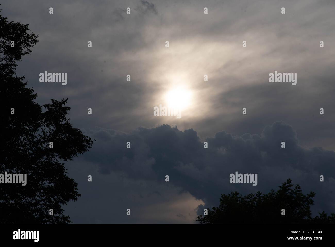 Rain clouds contrasting with the sun at the end of the day Stock Photo ...