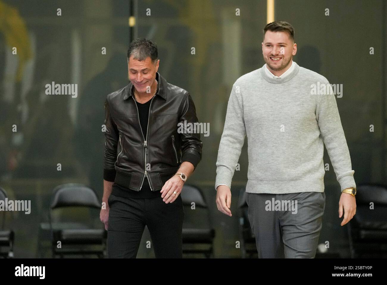 Los Angeles Lakers' Luka Doncic, right, walks to the podium with ...