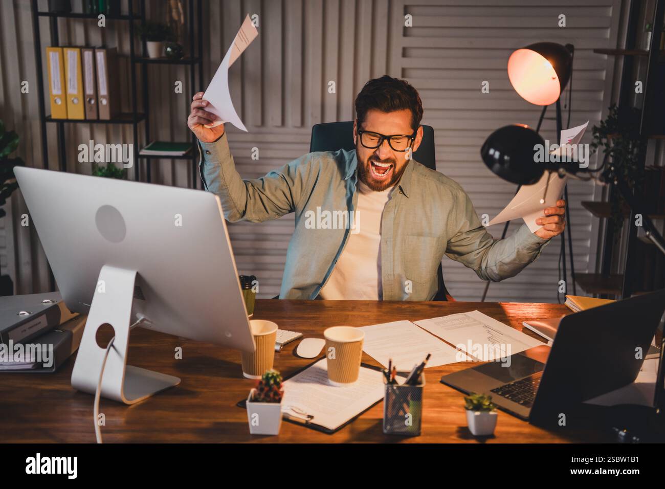 Young businessman reacts strongly to office work stress Stock Photo - Alamy