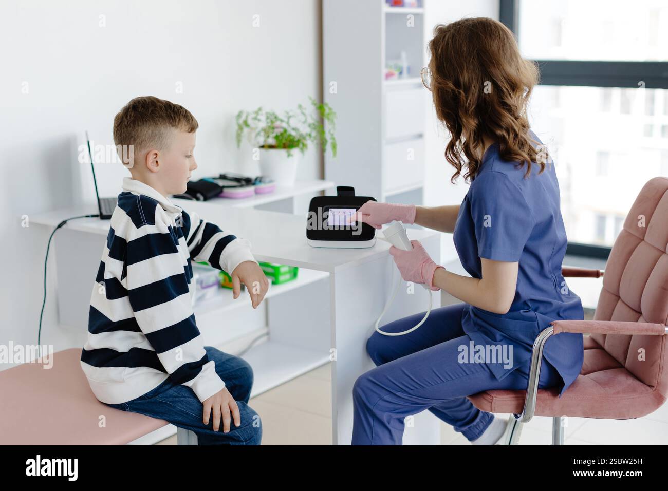 Boy testing breathing function by spirometry in doctors office ...