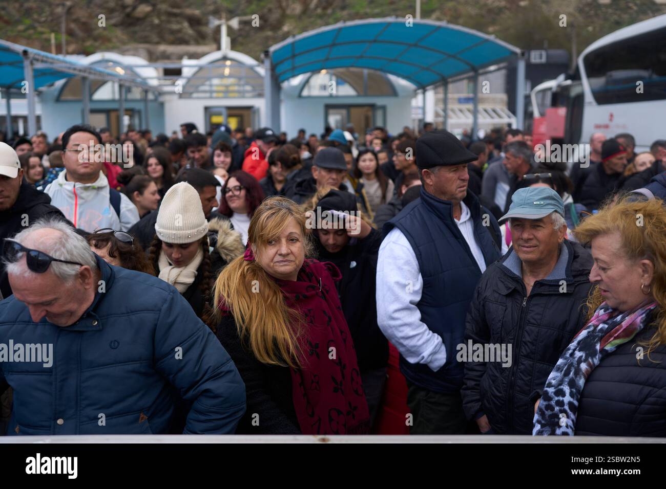 Passengers wait to board a ferry bound for the Greek mainland, in the ...