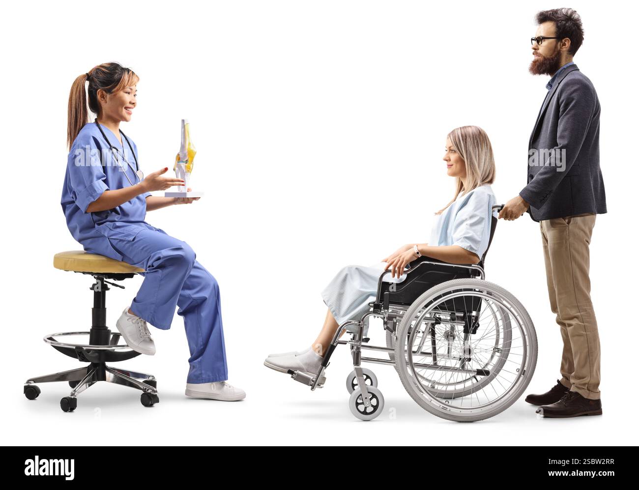 Asian medical worker explaining a knee bone model to a young female ...