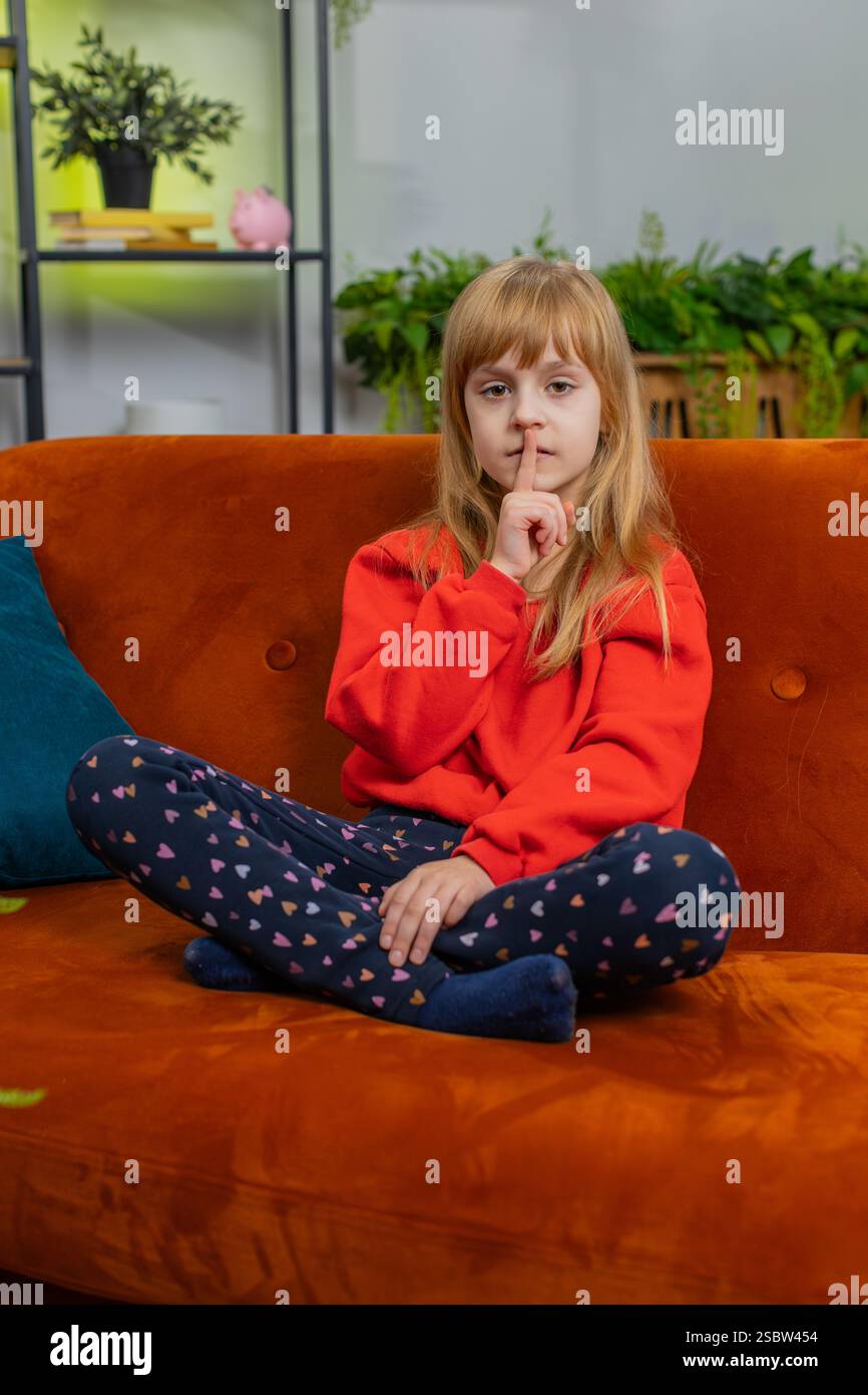 Shh be quiet please. Preteen child girl presses index finger to lips ...