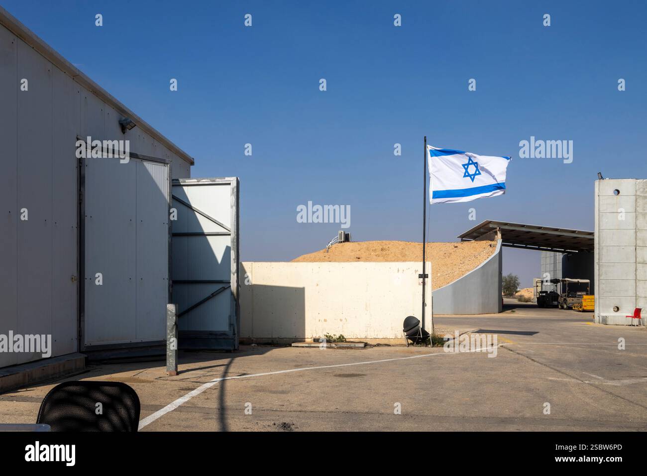 An Israeli flag flying over a construction quarry and hangars Stock ...