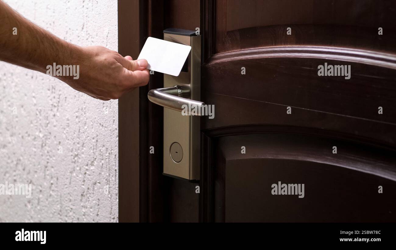Hand opening hotel door with electronic card key and entering room ...