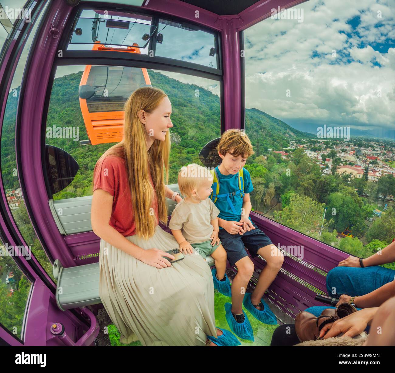 Mother and two sons on a cable car ride in Orizaba, Mexico. Scenic ...