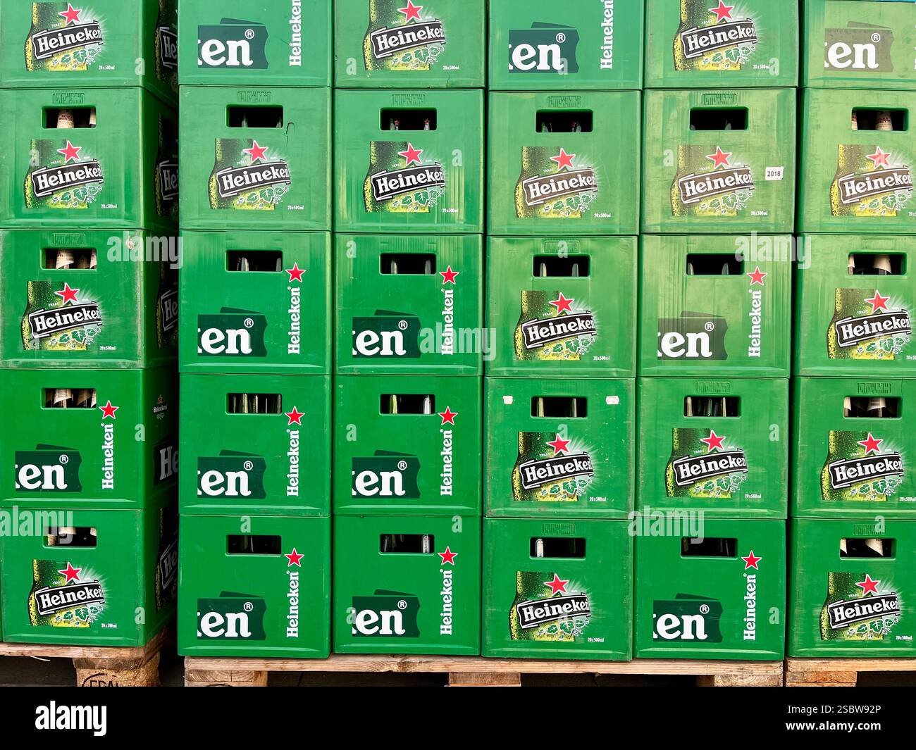 Piles of Heineken beer crates in a warehouse Stock Photo - Alamy