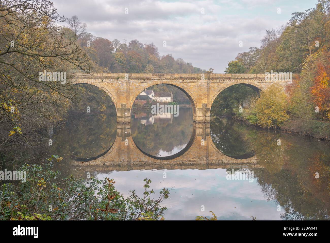Prebends Bridge surrounded by autumnal woodlands on the banks of the ...