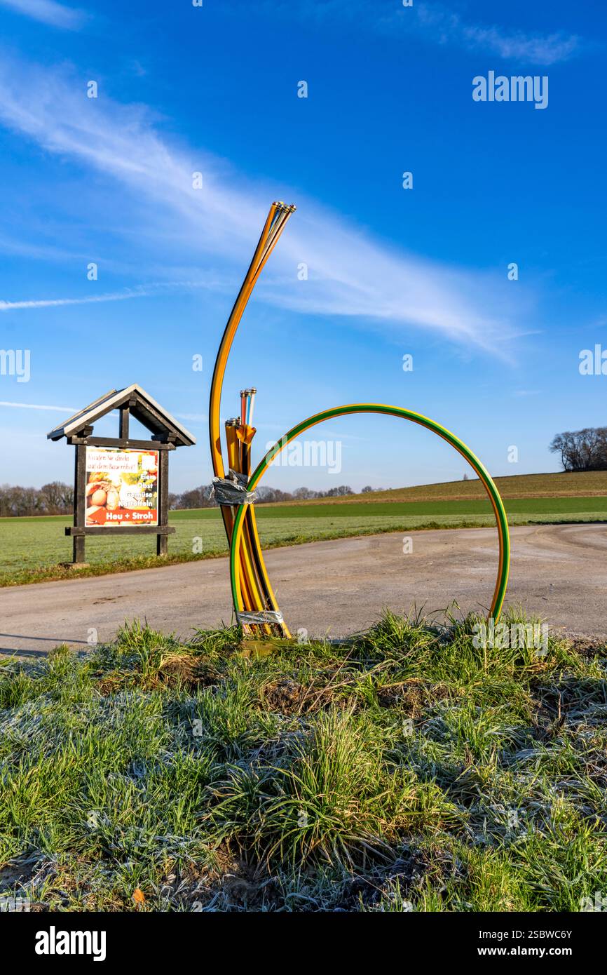 Fibre-optic connection: empty conduits poke out of the ground on a dirt ...