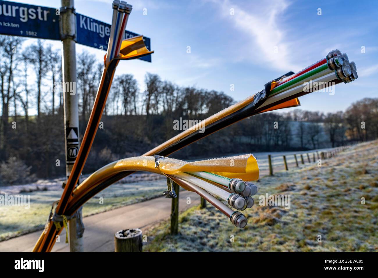 Fibre-optic connection: empty conduits poke out of the ground on a dirt ...
