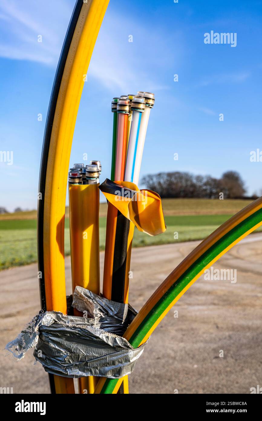 Fibre-optic connection: empty conduits poke out of the ground on a dirt ...
