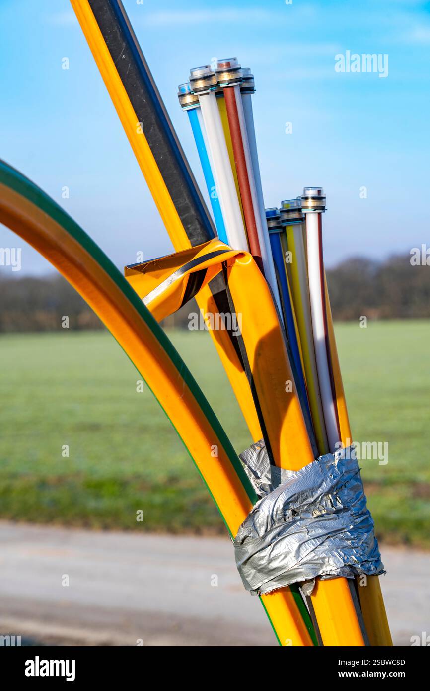 Fibre-optic connection: empty conduits poke out of the ground on a dirt ...