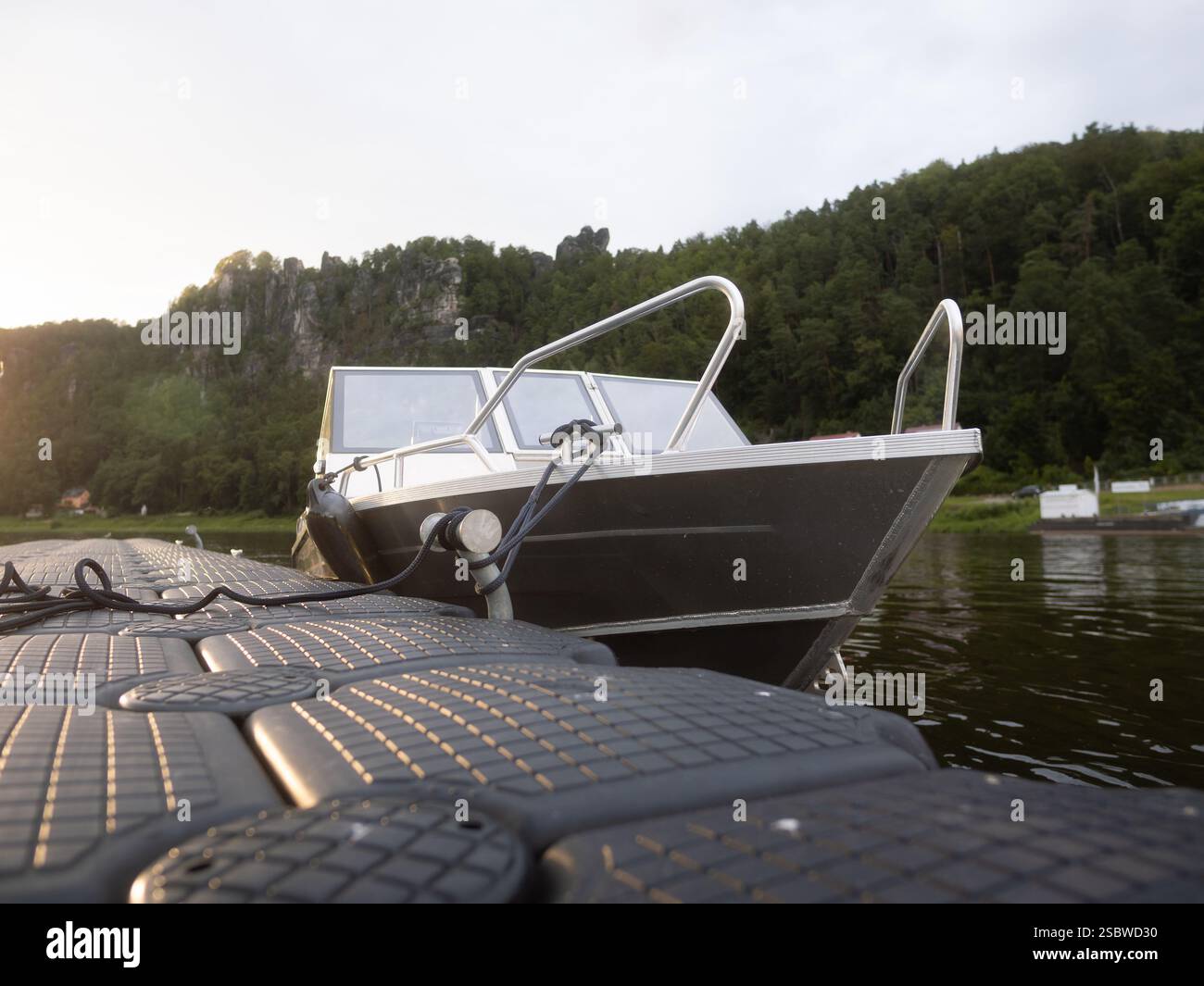 Motor boat out of aluminum anchoring next to a river. Empty aluminum ...