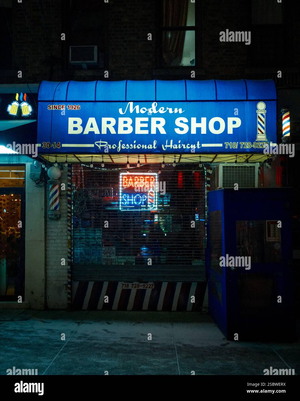 Modern Barber Shop storefront at night in Astoria, Queens, New York ...