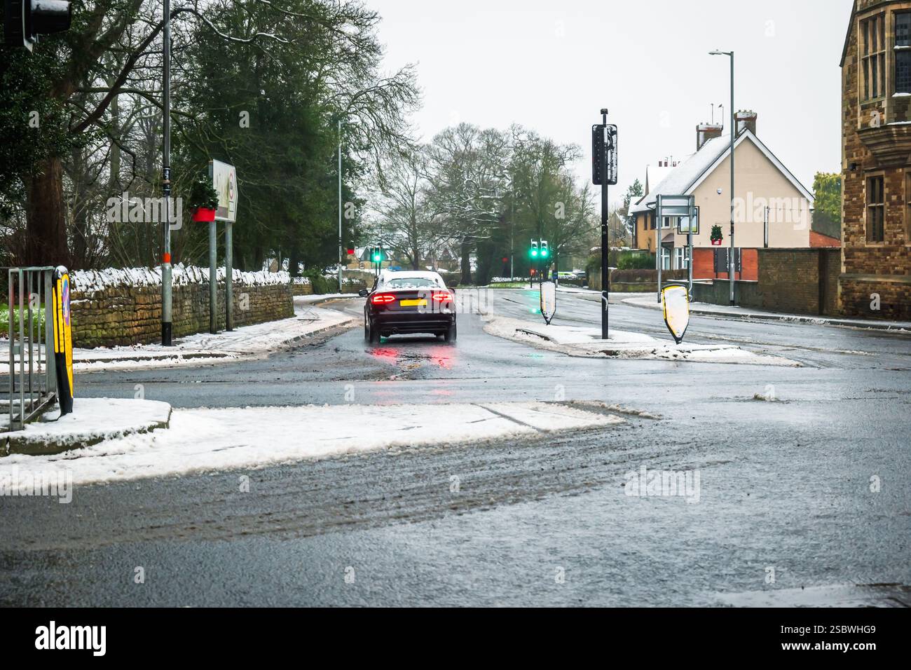 Frost snow covered british road and cars in england uk Stock Photo - Alamy