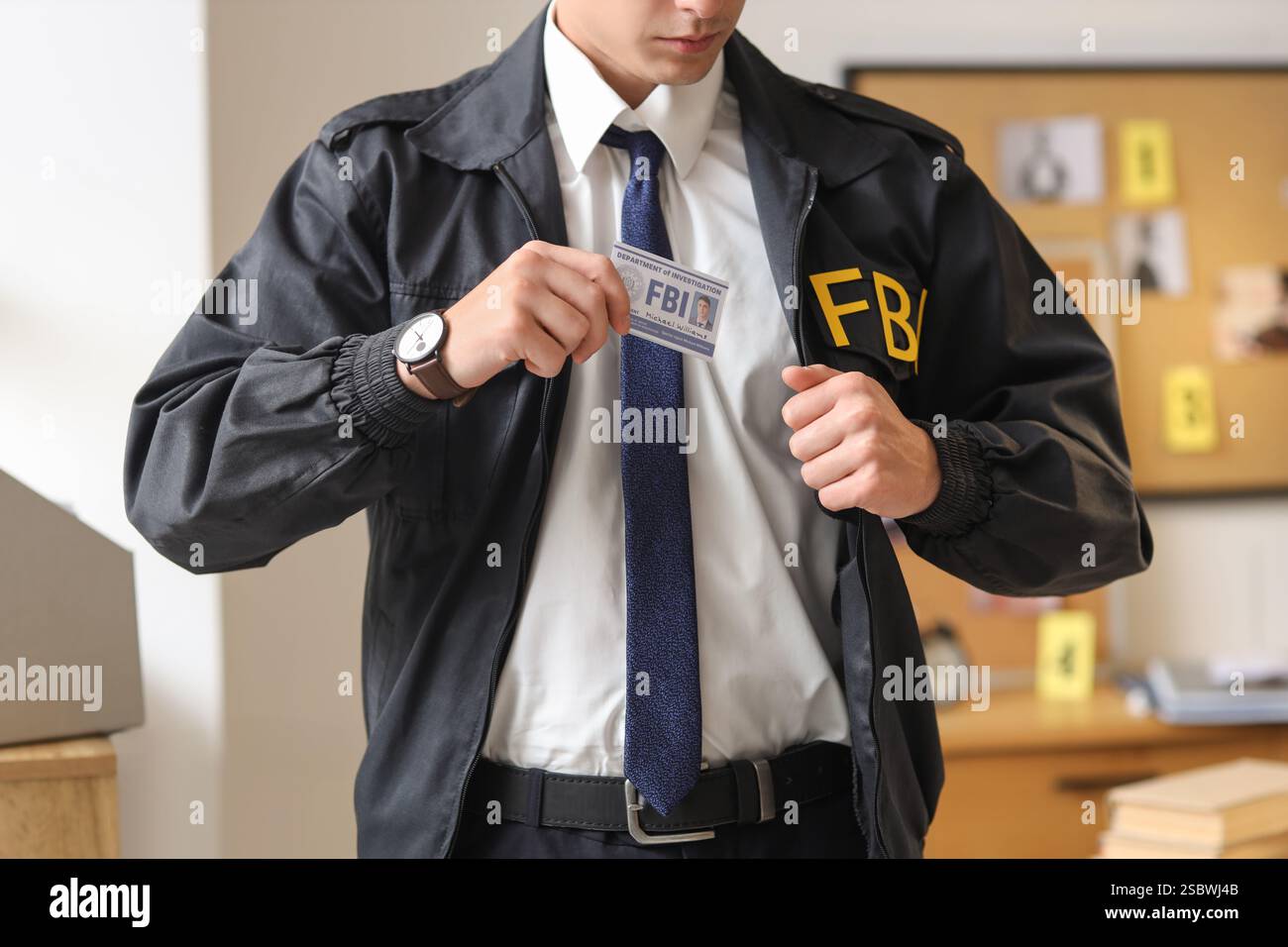 Male FBI agent with document in office, closeup Stock Photo - Alamy