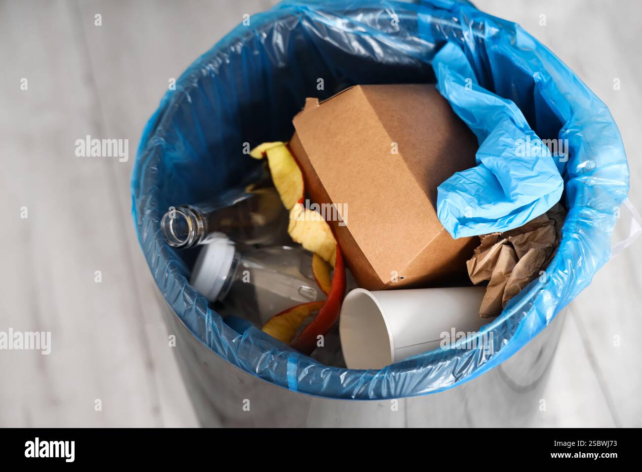 Trash bin full of garbage in kitchen, closeup Stock Photo - Alamy