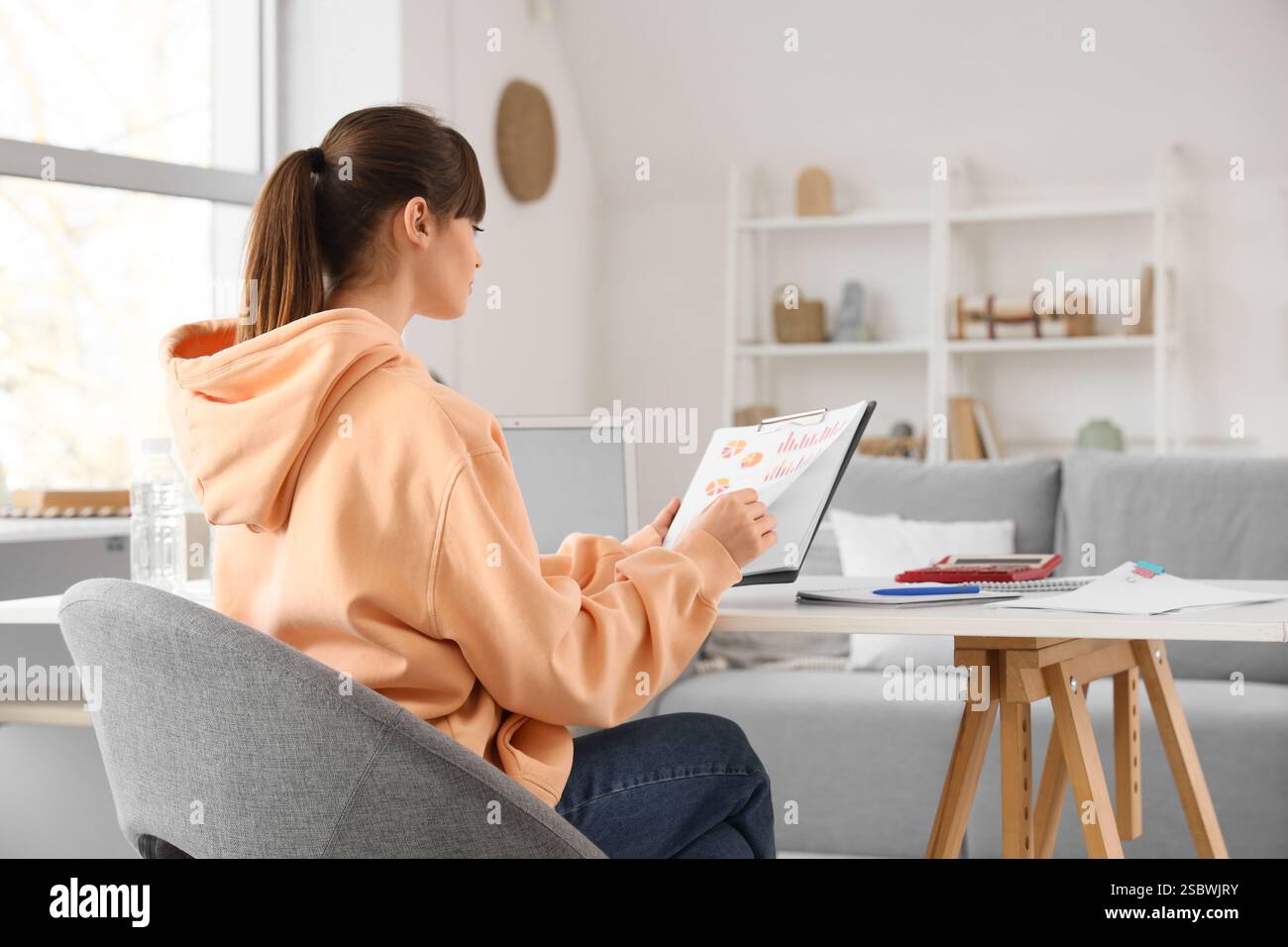 Teenage girl with diagrams working online at home Stock Photo - Alamy