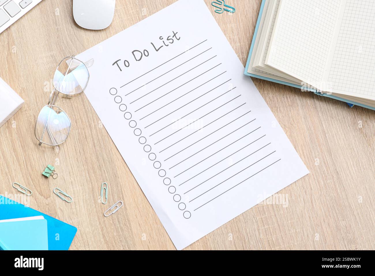 Empty to-do list with eyeglasses and stationery on wooden table Stock ...