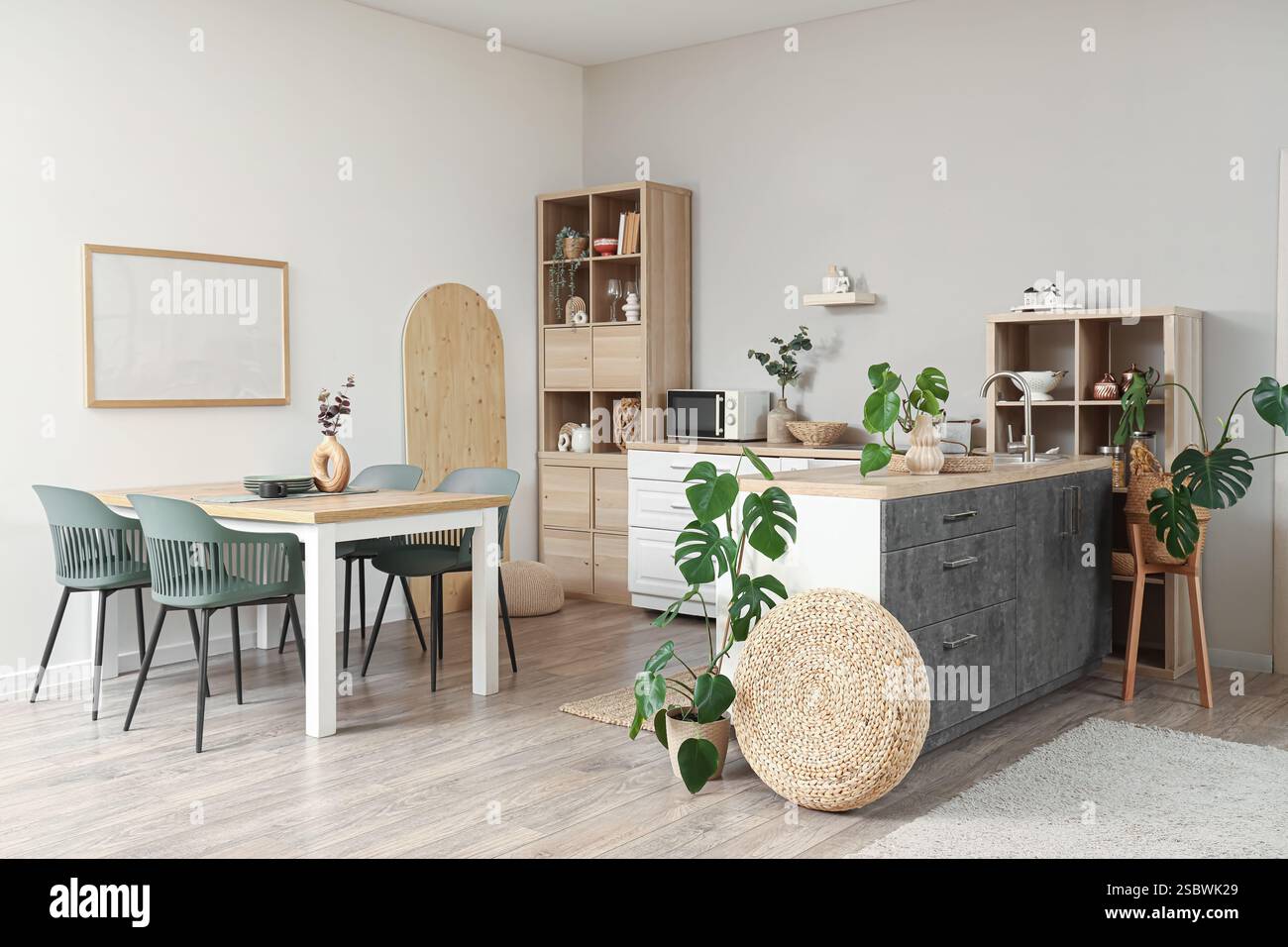 Interior of kitchen with dining table, counters and shelf units Stock ...