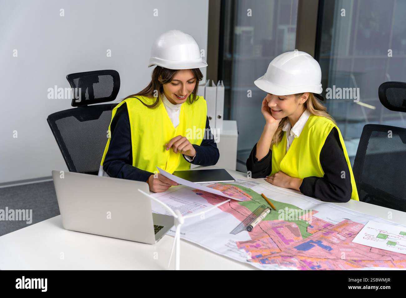 Two female engineers looking involved and excited while working ...