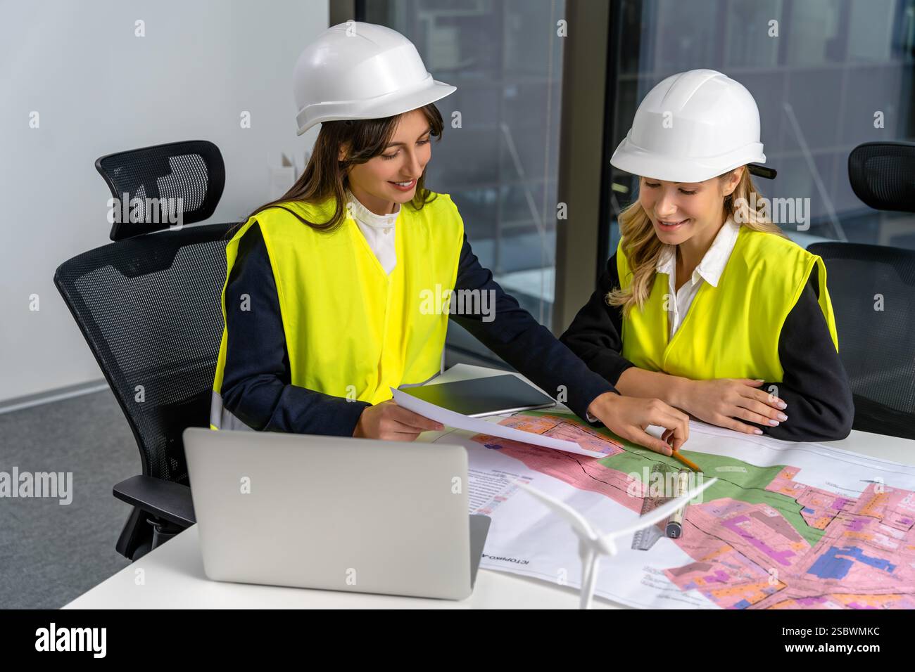 Two female engineers looking involved and excited while working ...