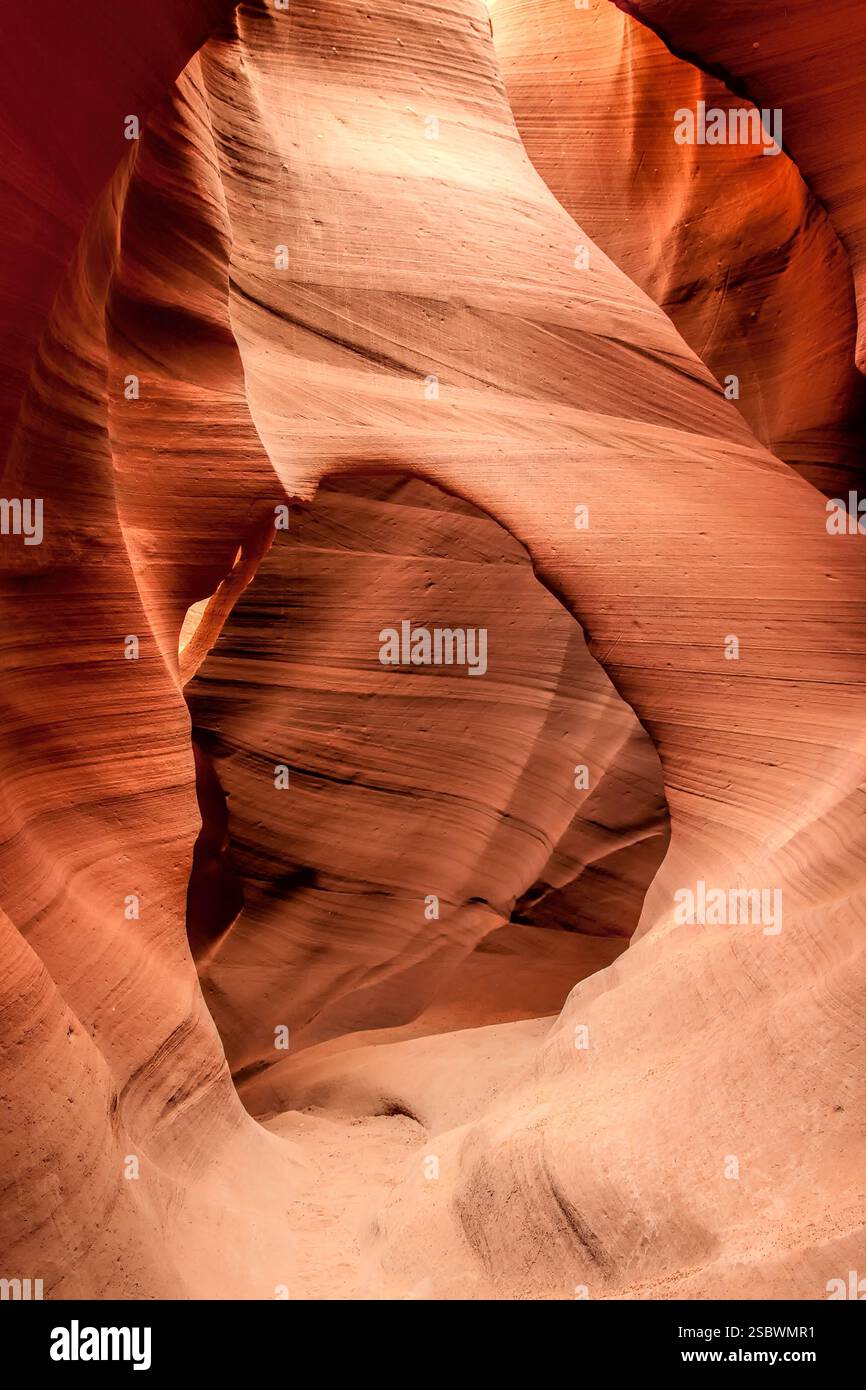 A canyon with a large hole in the middle. The canyon is brown and rocky ...