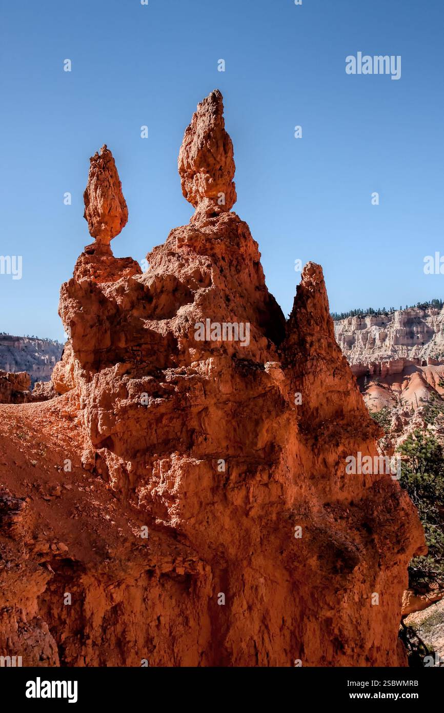 A large rock formation with two smaller rocks on top of it. The rocks ...