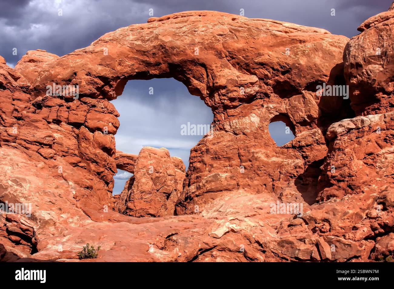 A large rock formation with a hole in the middle. The hole is shaped ...
