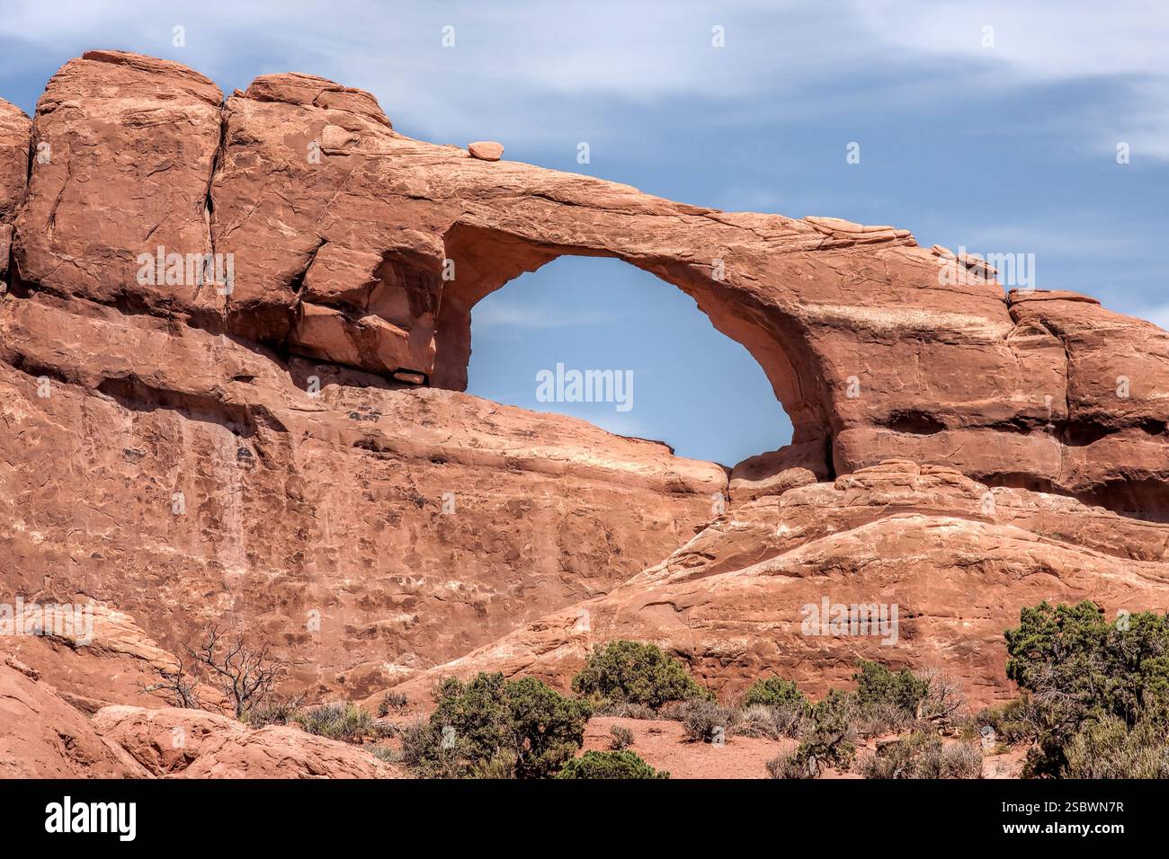 A large rock formation with a large hole in the middle. The hole is ...