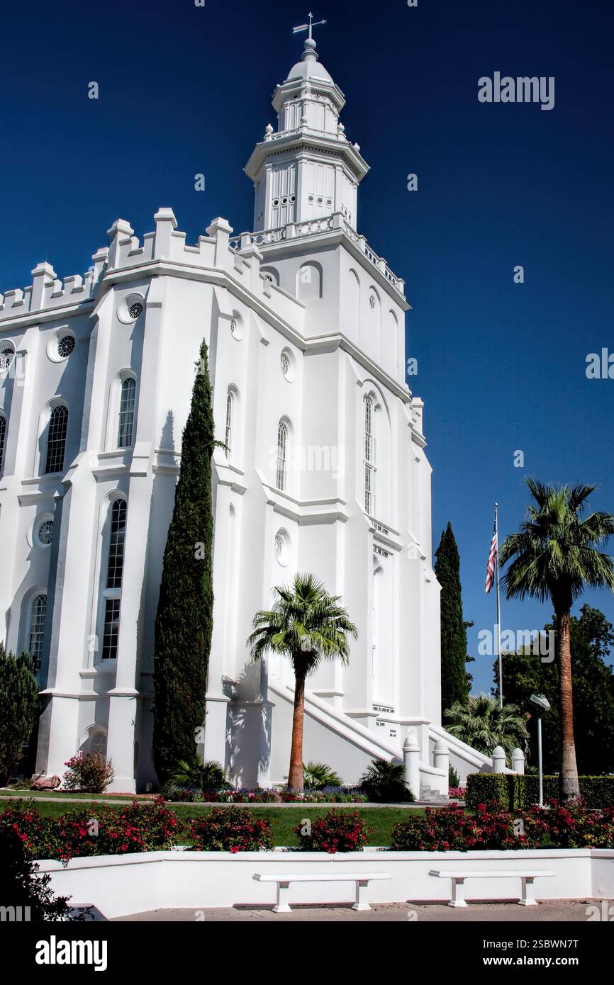 A large white church with a cross on top. The building is surrounded by ...