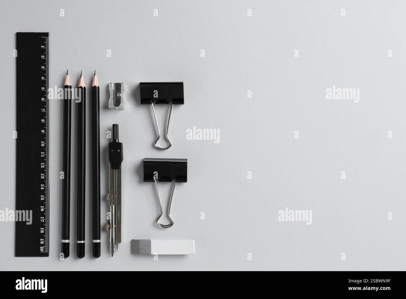 Flat lay composition with ruler and other stationery on light grey ...