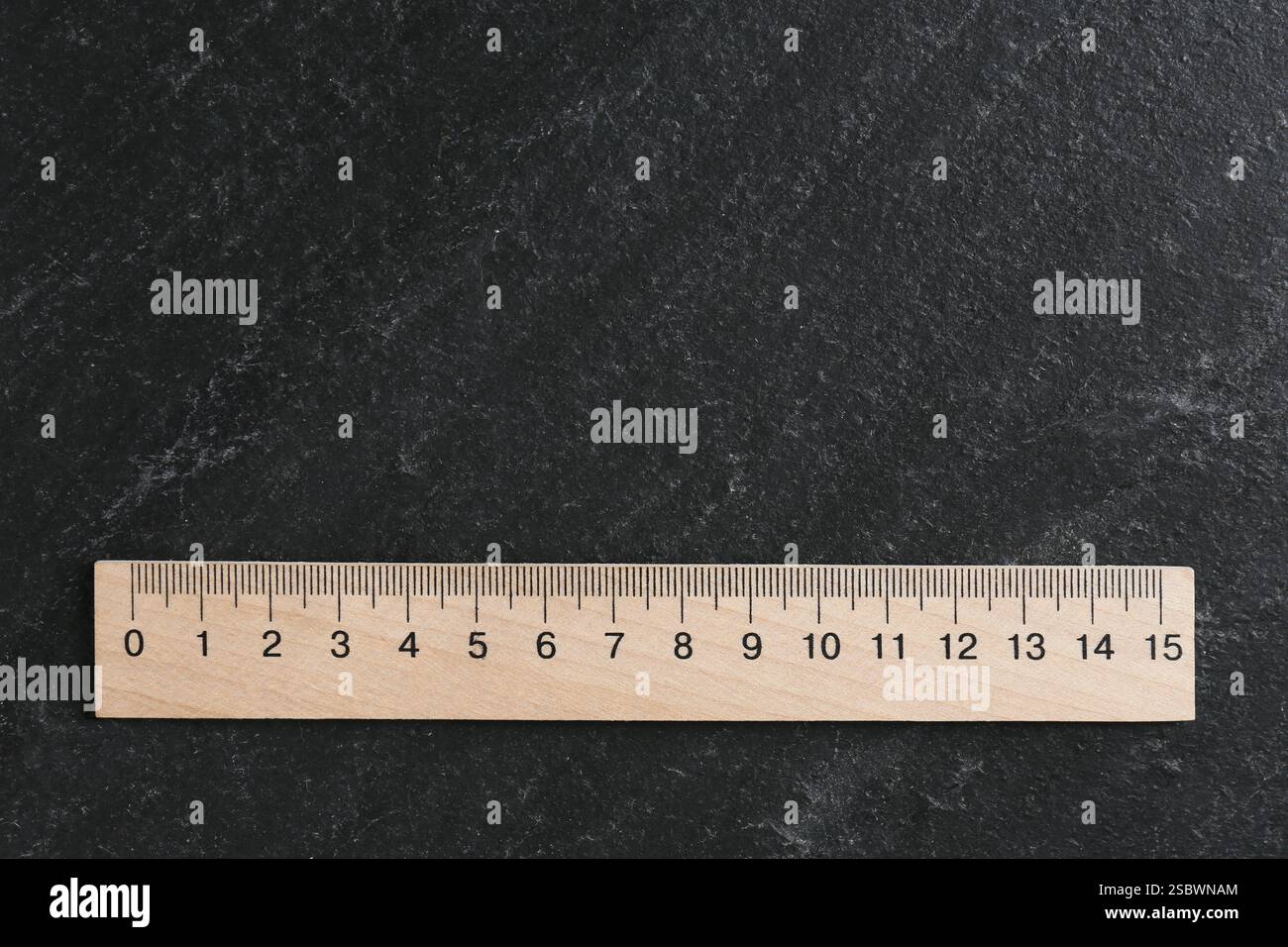 One wooden ruler on black table, top view. Space for text Stock Photo ...