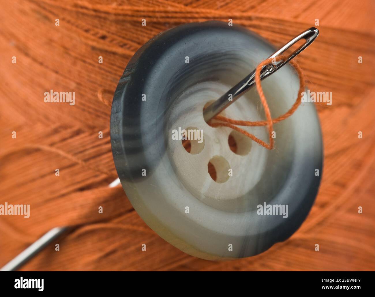 Button pinned the needle to the reel of thread Stock Photo - Alamy