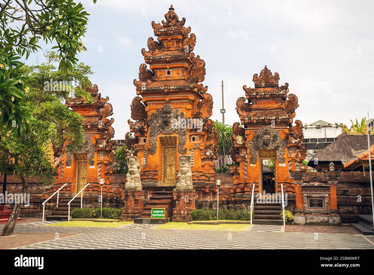 Intricate Balinese architecture: A vibrant orange temple gateway ...