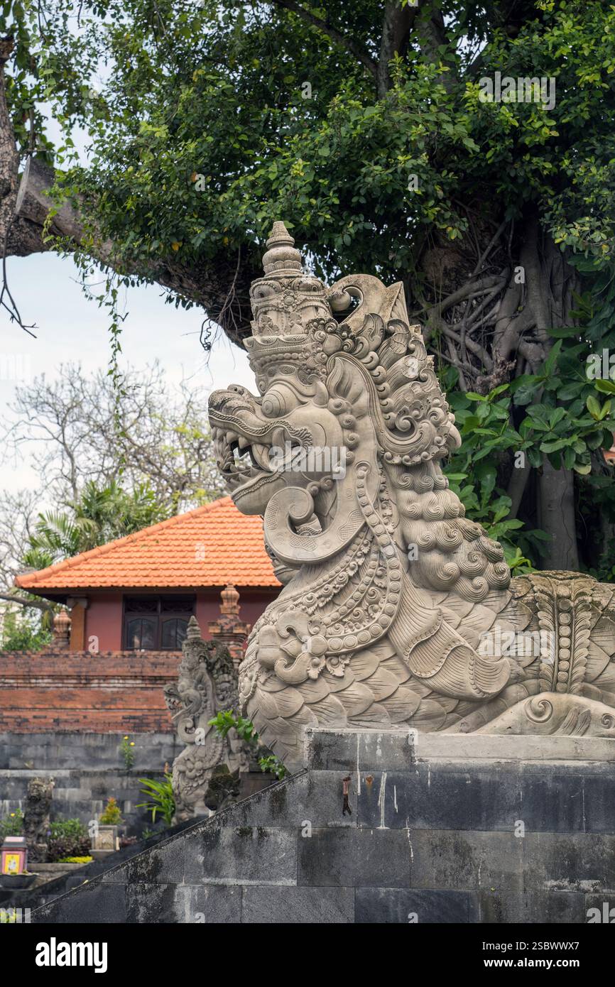 An ornate stone statue of a mythical beast in Bali, featuring elaborate ...
