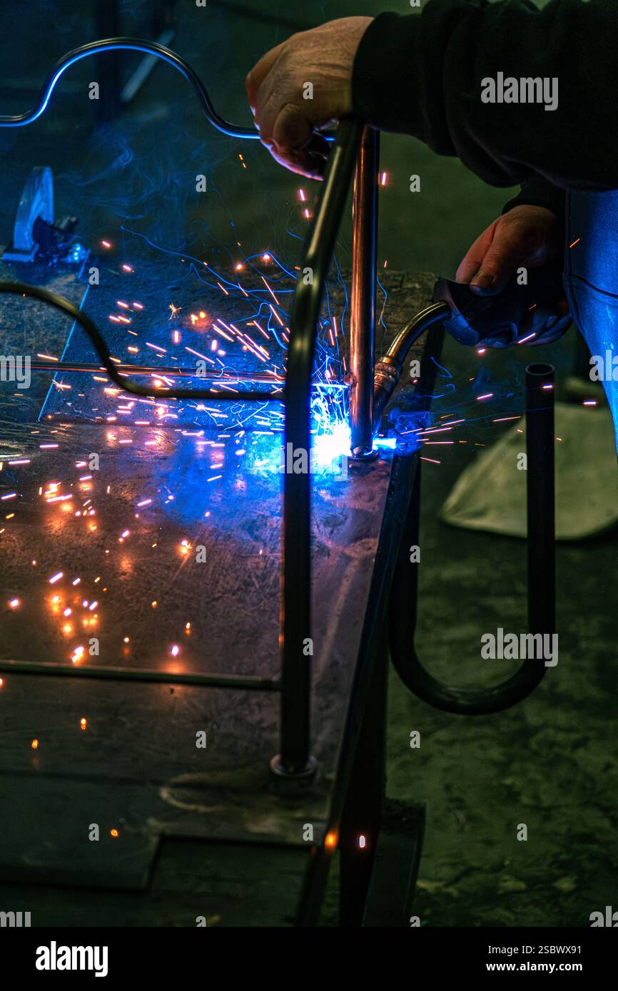 Welding sparks and flash fabrication worker Stock Photo - Alamy