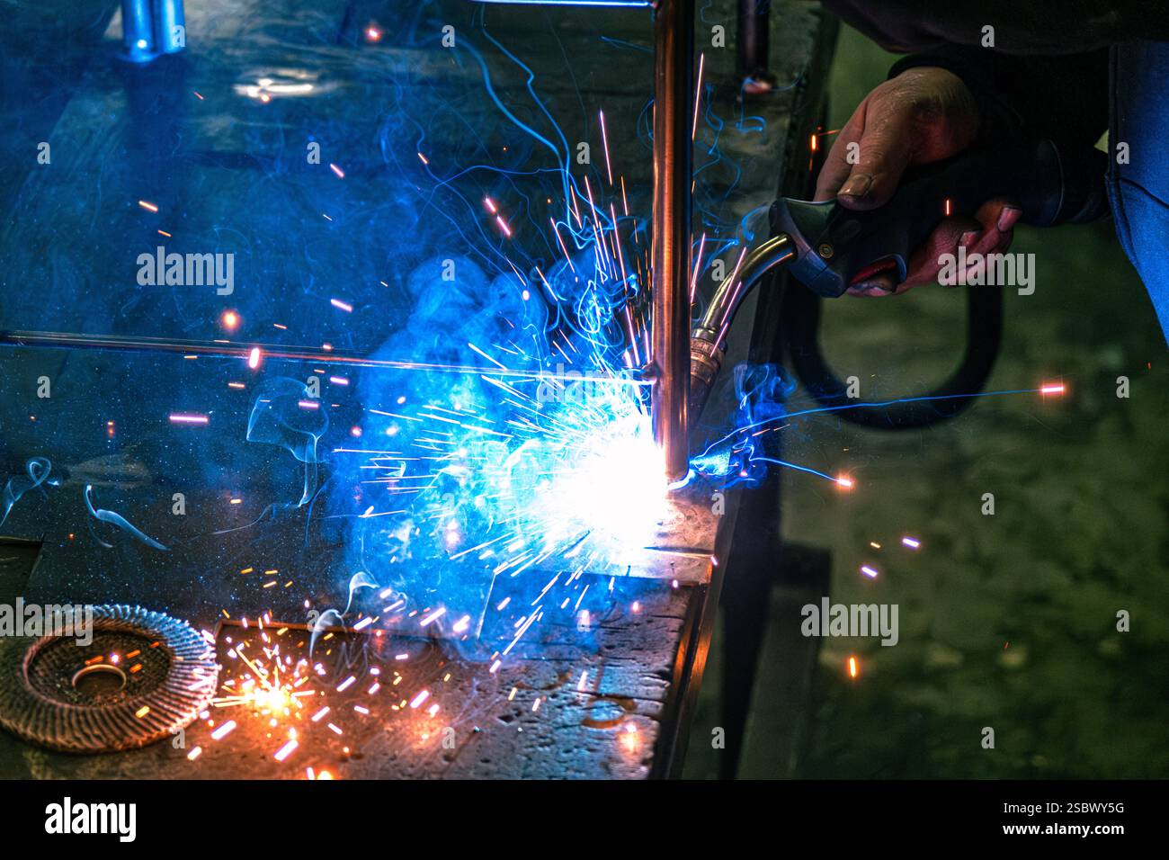 Welding sparks and flash fabrication worker Stock Photo - Alamy