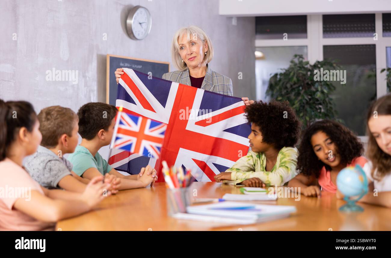 Female teacher showing british flag to kids in geography class Stock ...