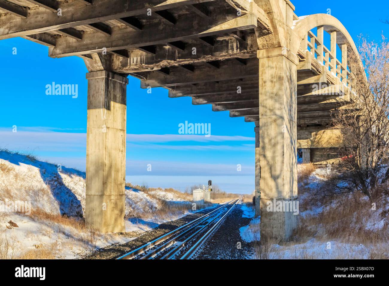 Bridge with a train track underneath it. The bridge is made of concrete ...