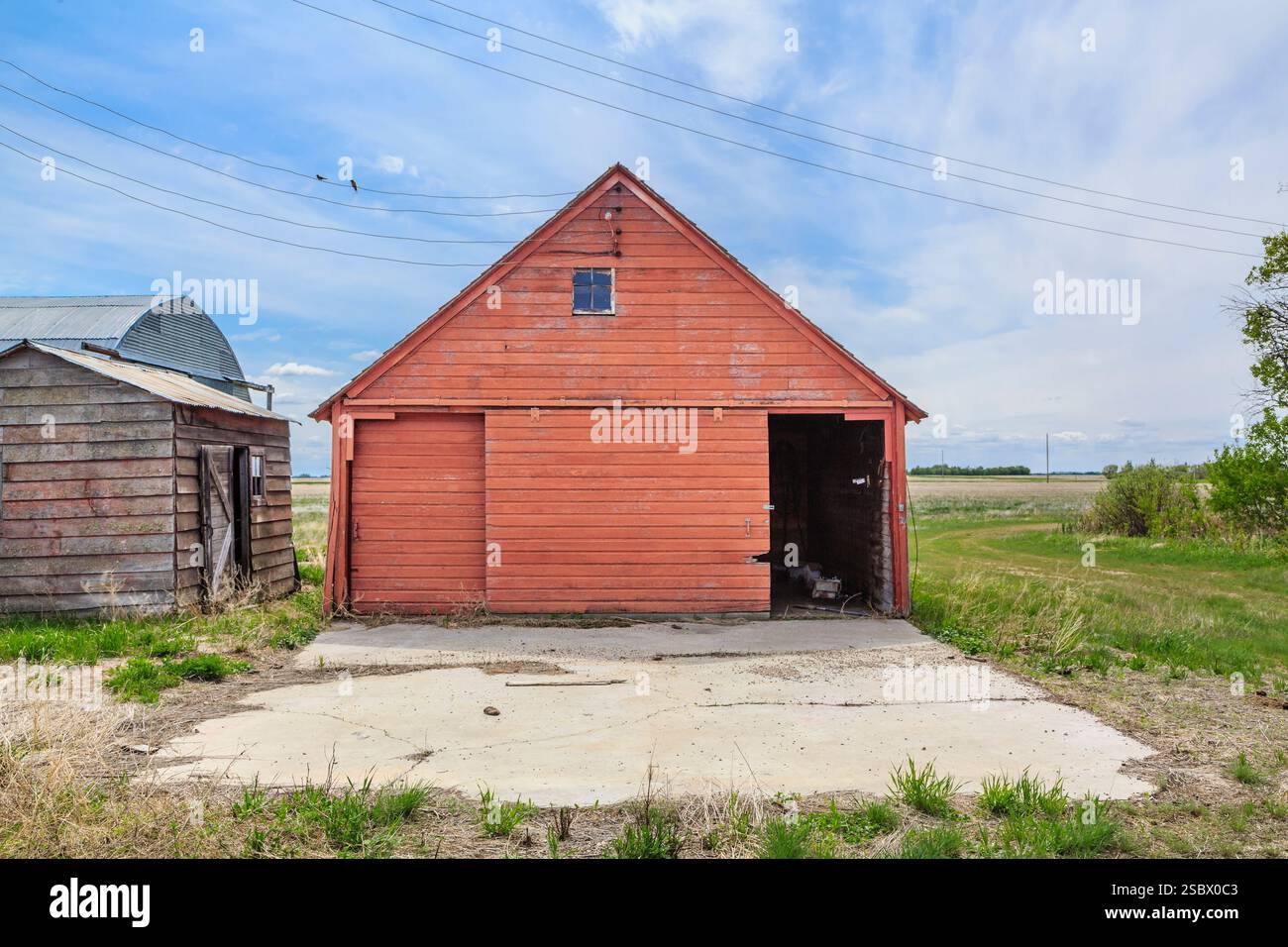 Red barn with a garage and a shed. The barn is empty. The garage is ...